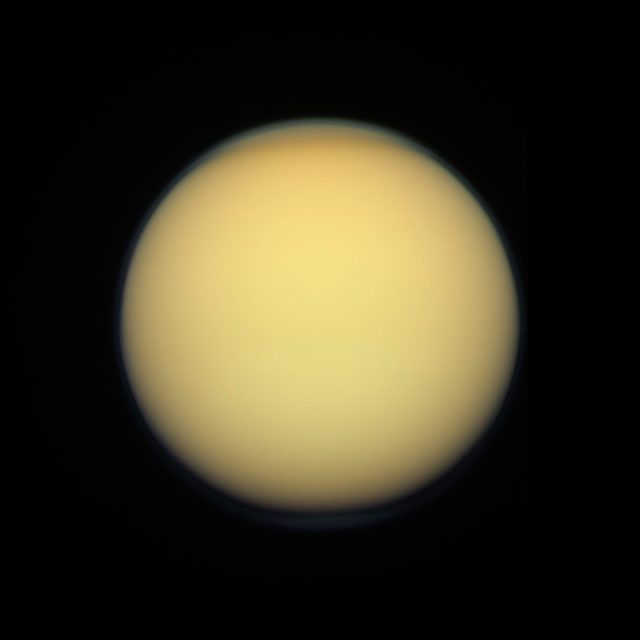 Why Does Titan Have a Dense Atmosphere?